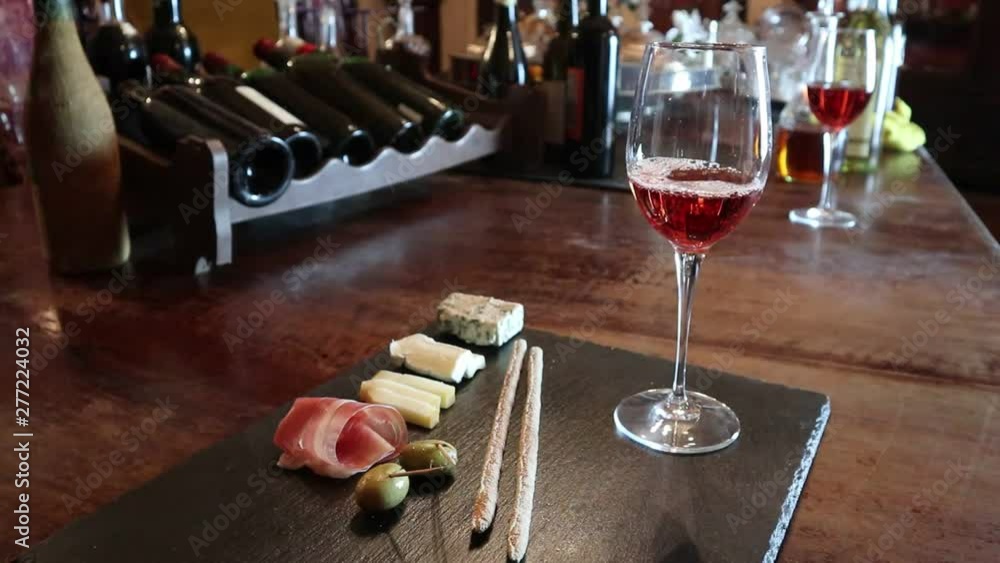Wine test, crystal glass, red wine, cheese, bar counter background ...