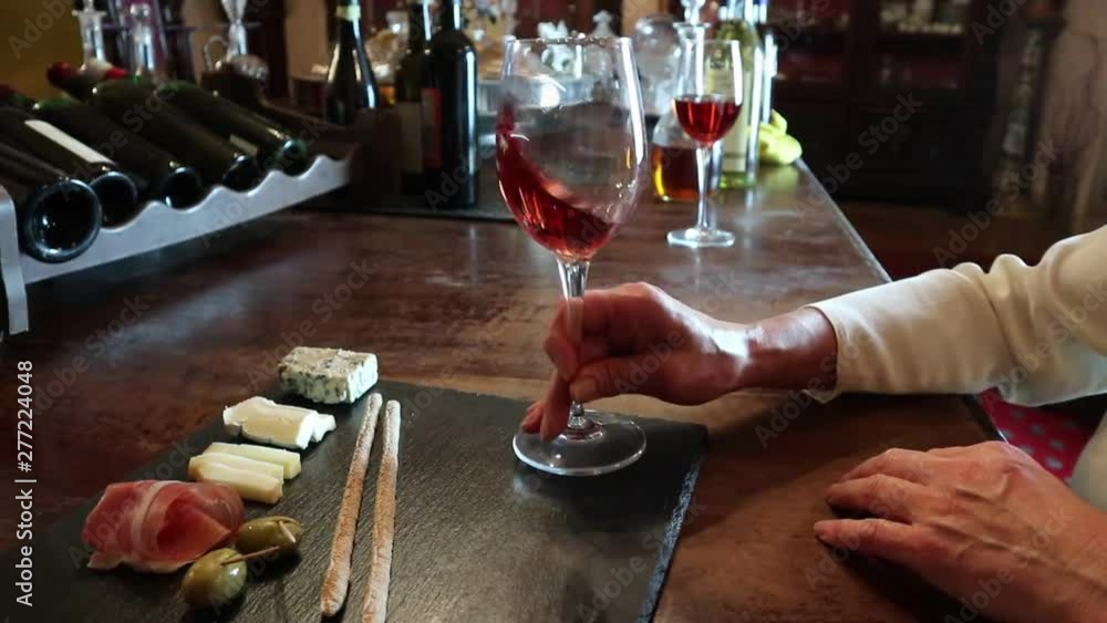 Wine test, crystal glass, red wine, cheese, bar counter background ...