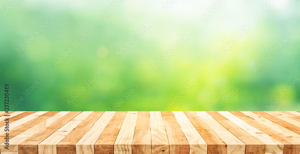 Real wood table top texture on blur fresh green garden background.For ...