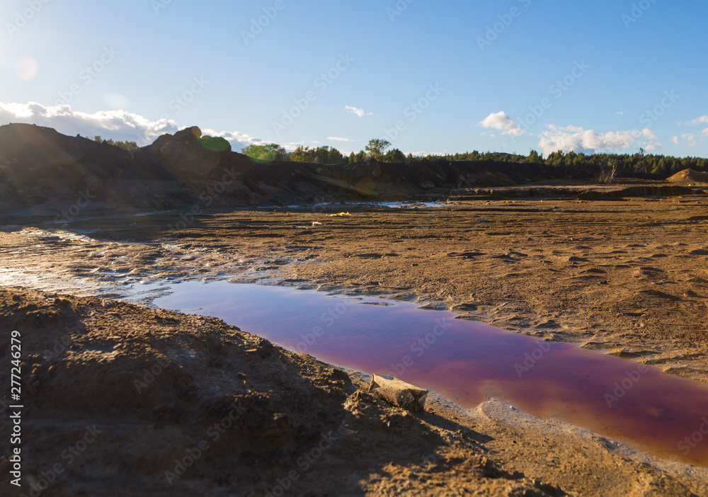 Water pollution of a copper mine exploitation. water maroon toxic color ...