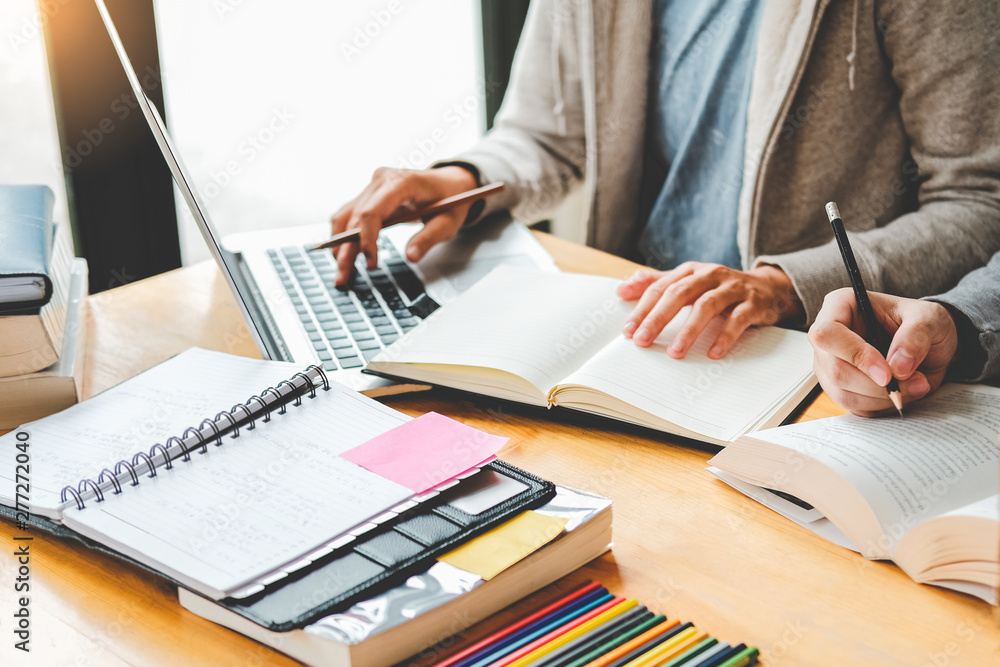 High school or college students studying and reading together in ...