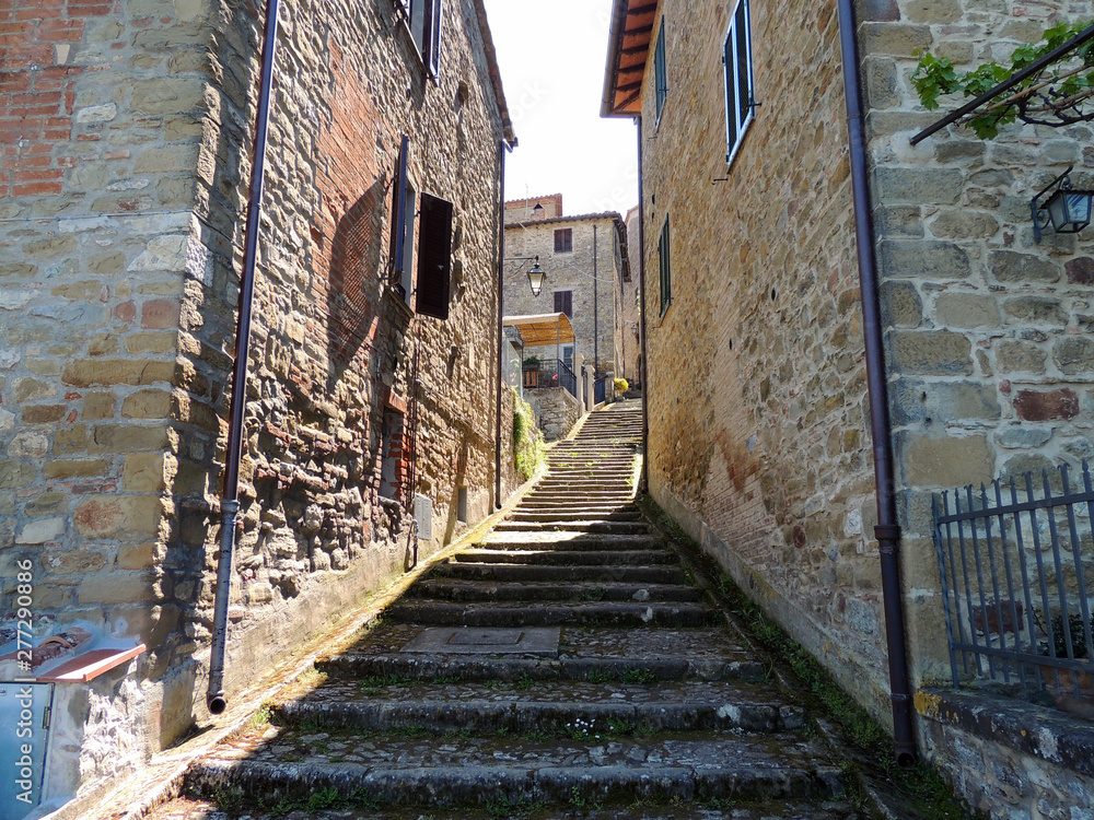 Steps of Monte del Lago between the ancient buildings. The village that ...