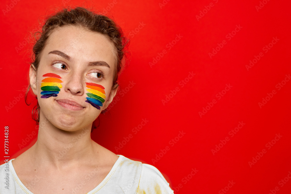 Girl with pride flag painted on her cheeks smiling Stock Photo | Adobe ...