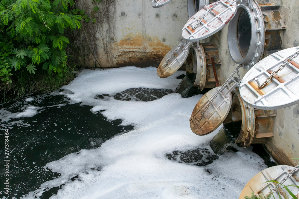 Waste water pipe from the factory flowing to the canal. Sewer pipes ...