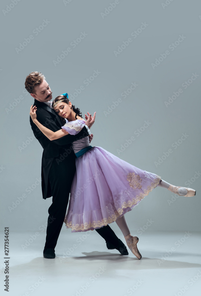Supporting. Beautiful contemporary ballroom dancers isolated on grey ...
