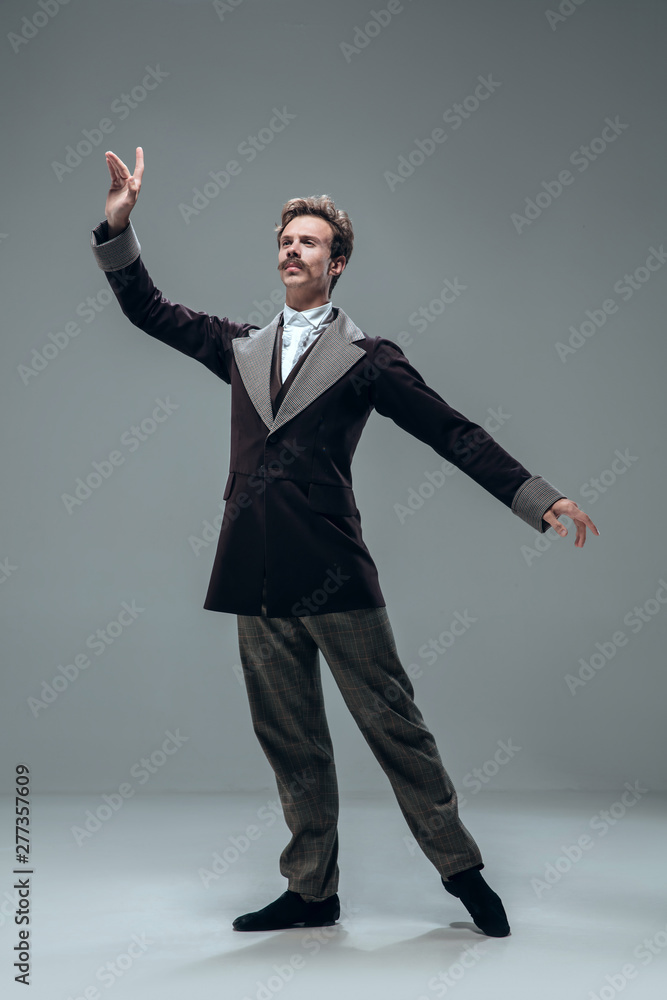 Strict. Beautiful contemporary ballroom dancer isolated on grey studio ...