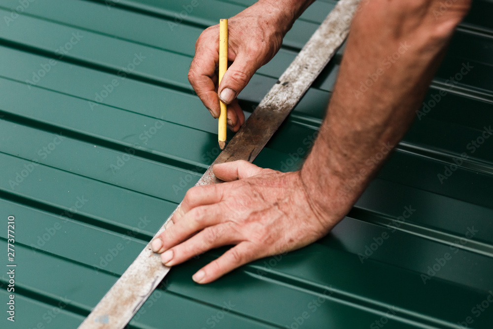 the master draws on metal with a simple pencil on a ruler, the master ...