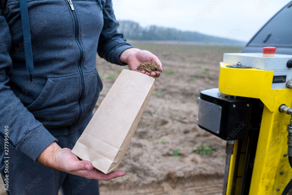 Soil Sampling. An engineer employee of a research laboratory packs a ...