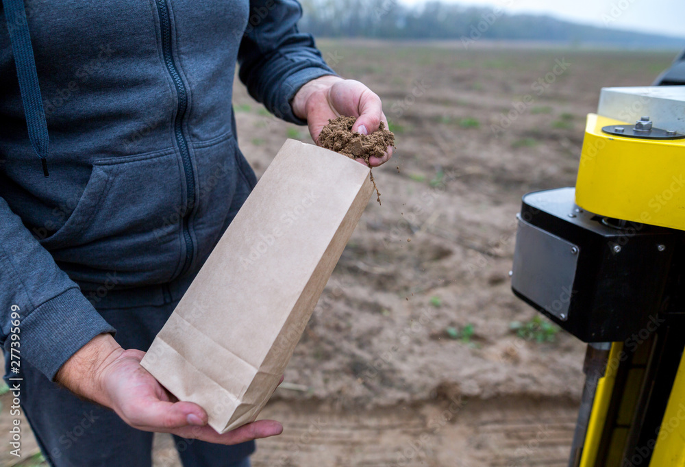 Soil Sampling. An engineer employee of a research laboratory packs a ...