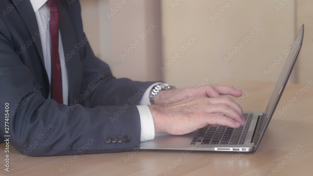 Unrecognisable old man without face typing on the keyboard laptop in ...