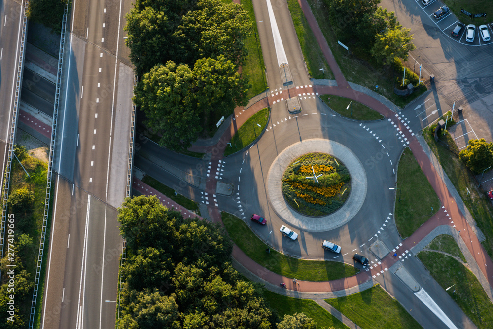 Cars on roundabout and intersecting roads Stock Photo | Adobe Stock