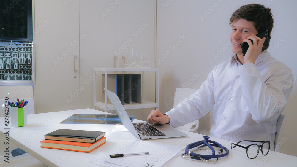 Happy doctor has phone conversation with patient. Caucasian man using ...
