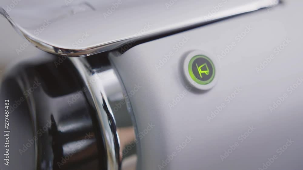 View of someone's finger pressing round shaped button with symbol of ...
