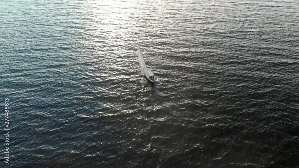 Aerial: Beautiful 4K following a small yacht boat water transport - a ...