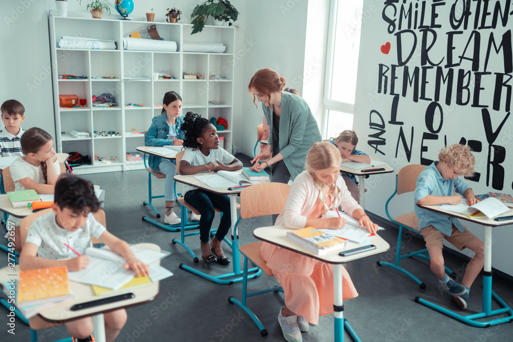Class of children working on their task during the lesson. Stock Photo ...