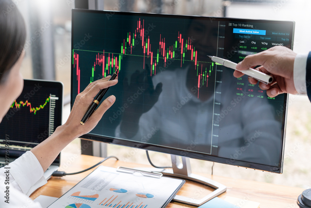 Team of stockbrokers Discussing with display screens Analyzing data ...