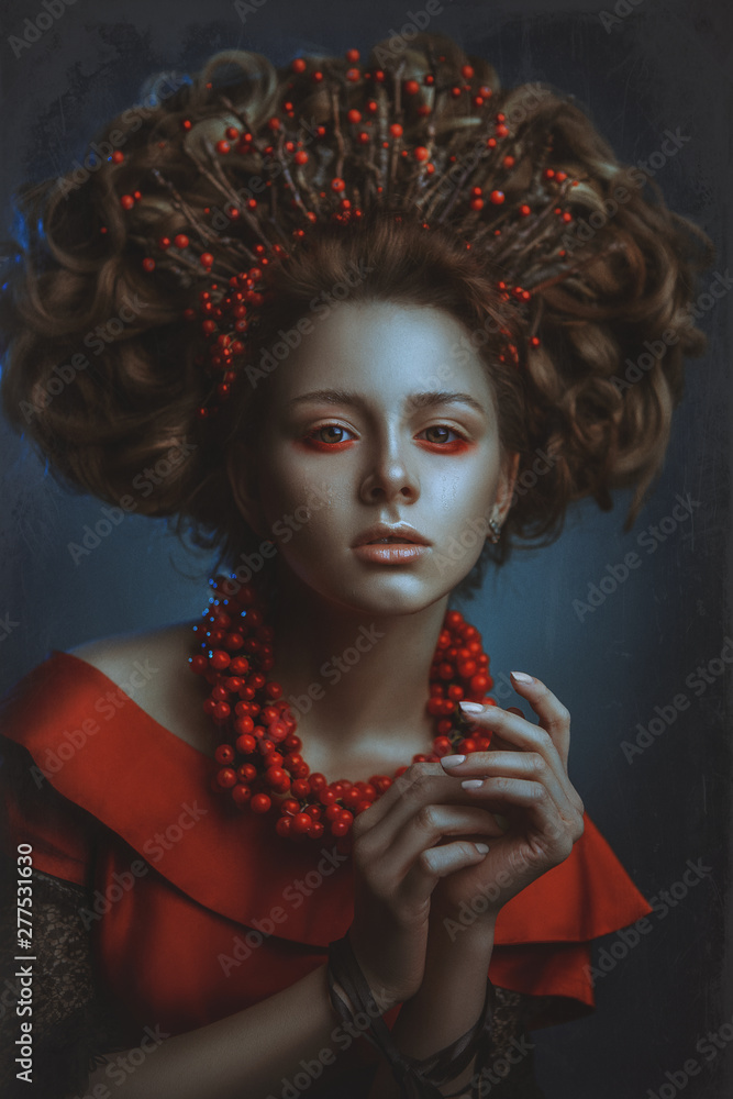 Beautiful young model wearing red dress is posing with a creative ...