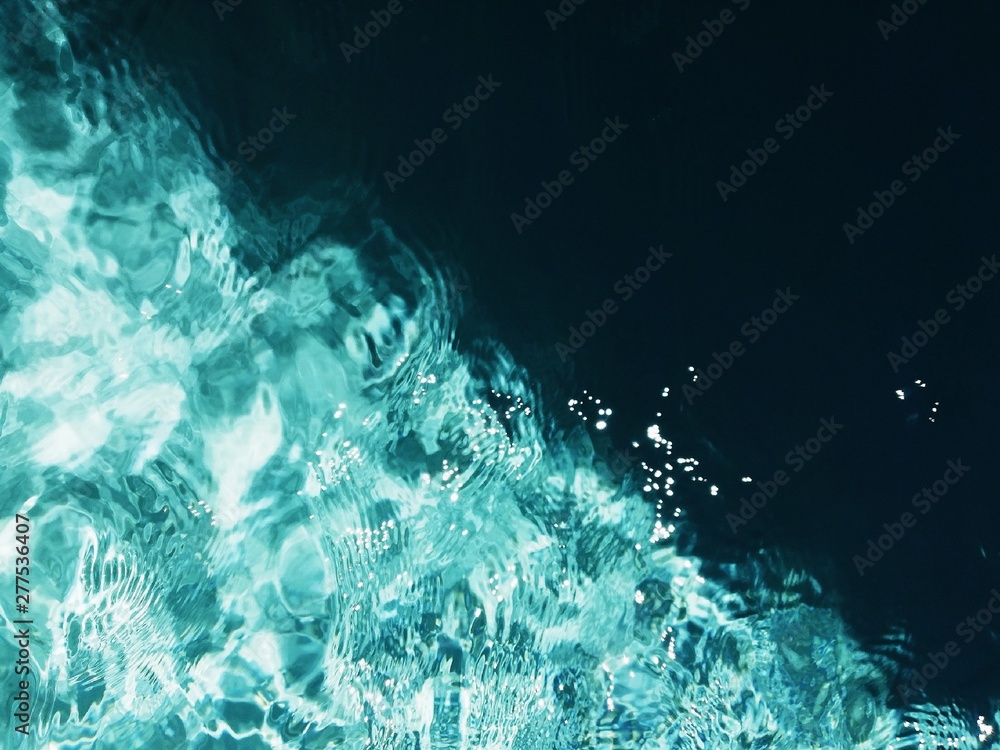 Light and shadow on water background. Swimming pool and blue rippled ...