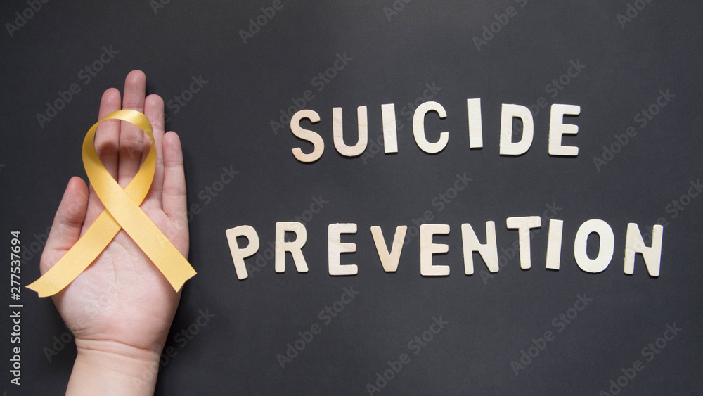 World suicide prevention day - Human hands holding yellow ribbon ...