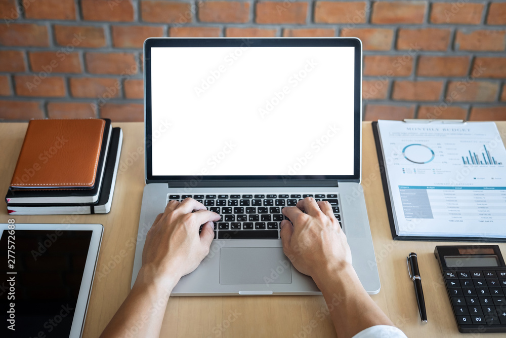 Image of Young man working in front of the laptop looking at screen ...