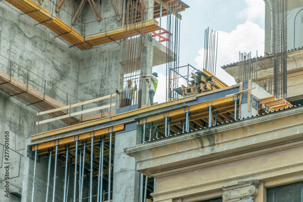 Builders install piles on the house. Home construction. Construction ...