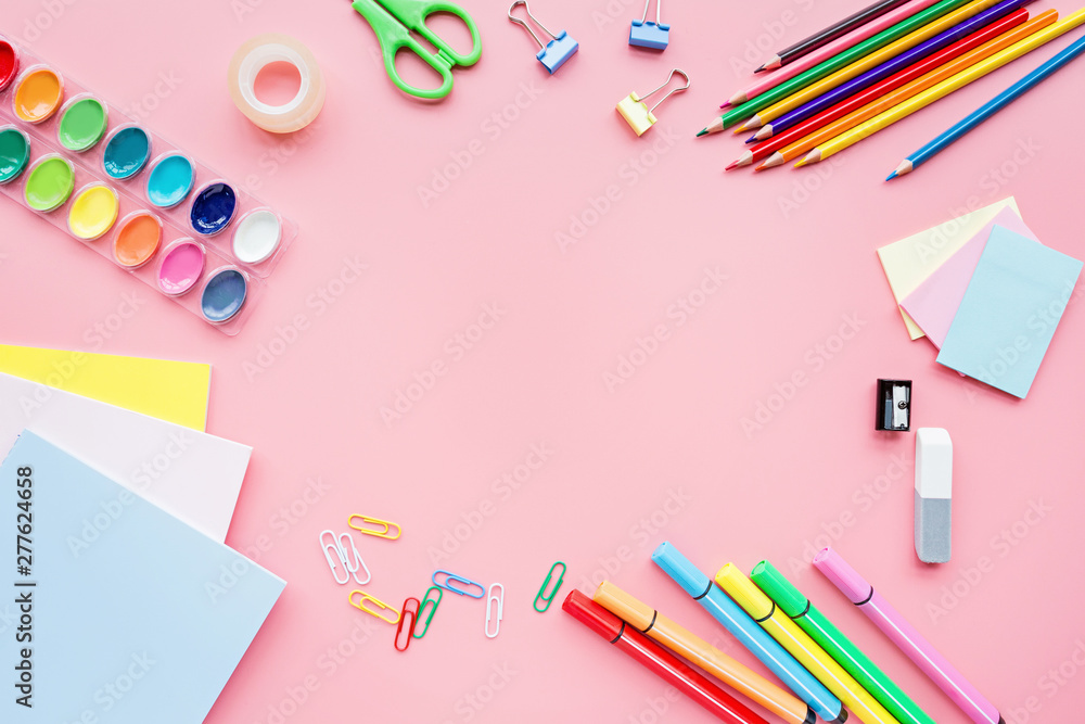 School supplies stationery, colour pencils, paints, paper on pink ...