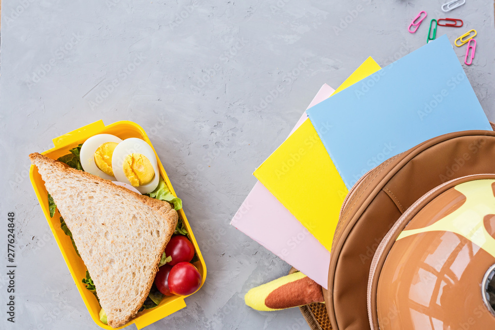 School supplies and lunch box with sandwich and vegetables. Back to ...