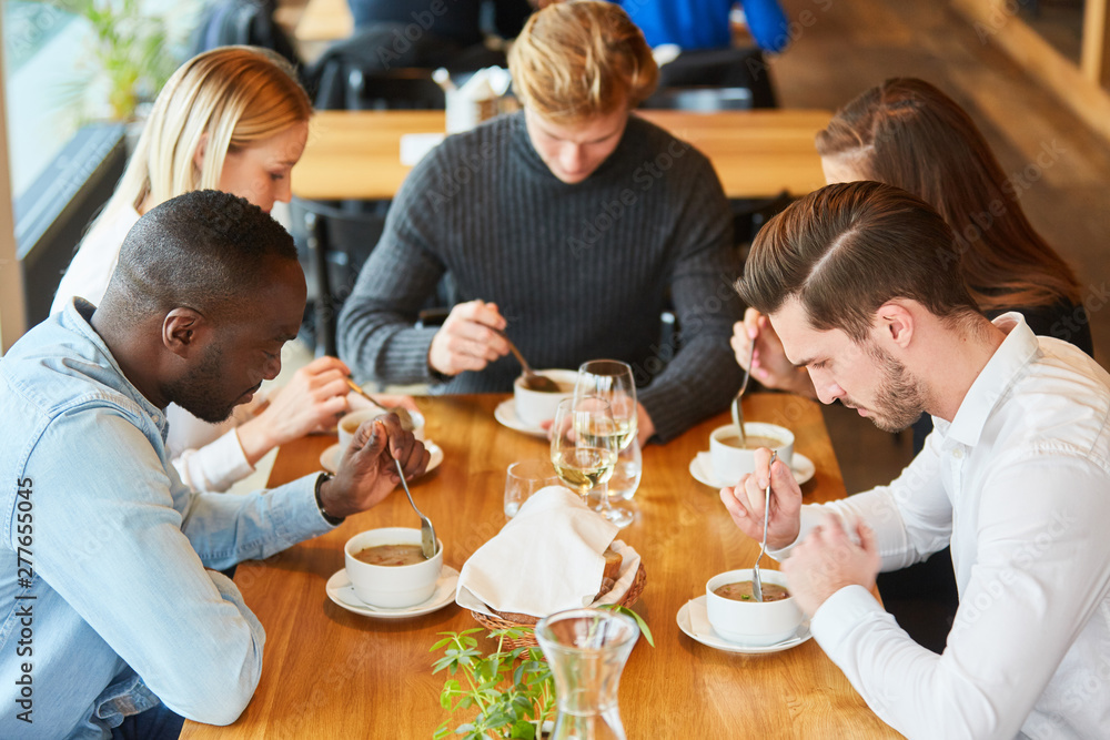 Young people eat soup together as a starter Stock Photo | Adobe Stock
