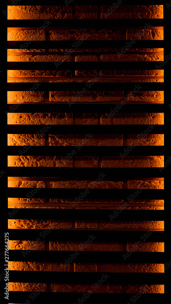 vertical background of brick with backlight on the grid. Conception ...