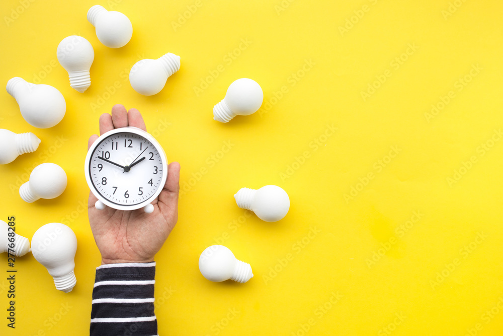 Time,dateline and creativity concepts with male hand holding clock with ...