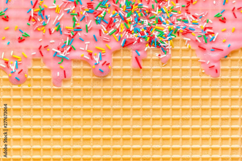golden waffle texture with pink icing and sprinkles, background for ...