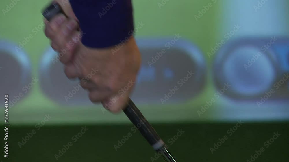 Pan from golf ball up club to hands in a golf simulator Stock Video ...