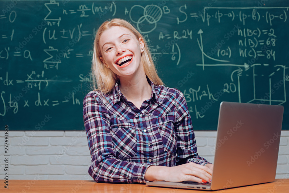 Teenage students with school notebook. Woman working on laptop computer ...