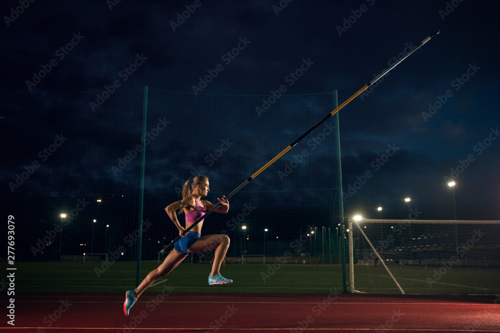 Ready to overcome difficulties. Professional female pole vaulter ...