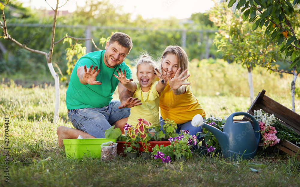 Happy family gardening together and taking care of nature. Plant ...