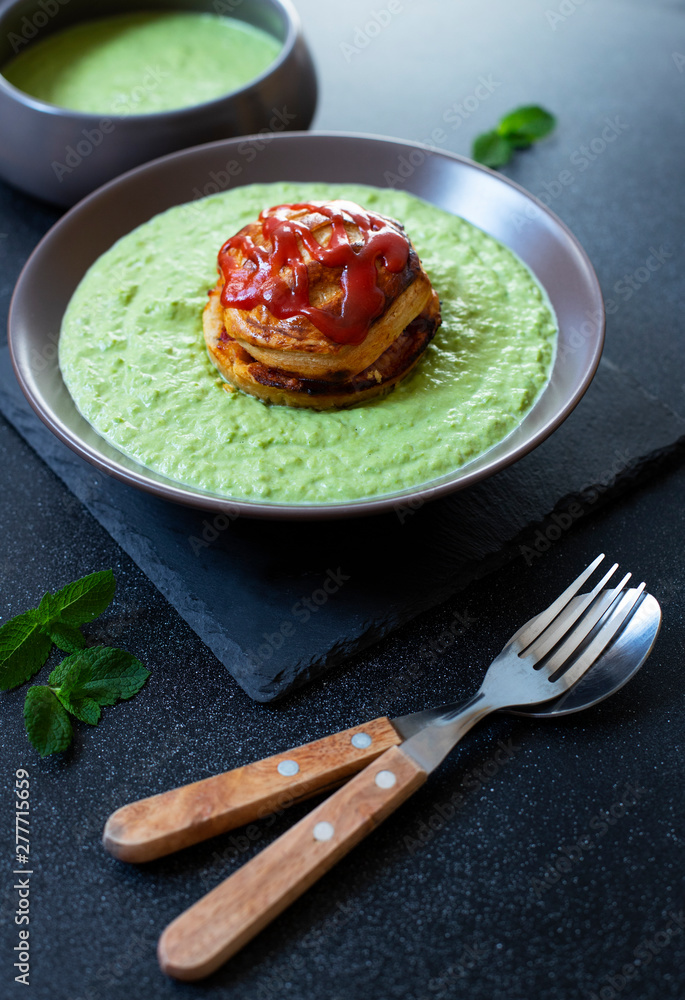 Traditional Australian dish called Pie Floater. Green pea soup served ...
