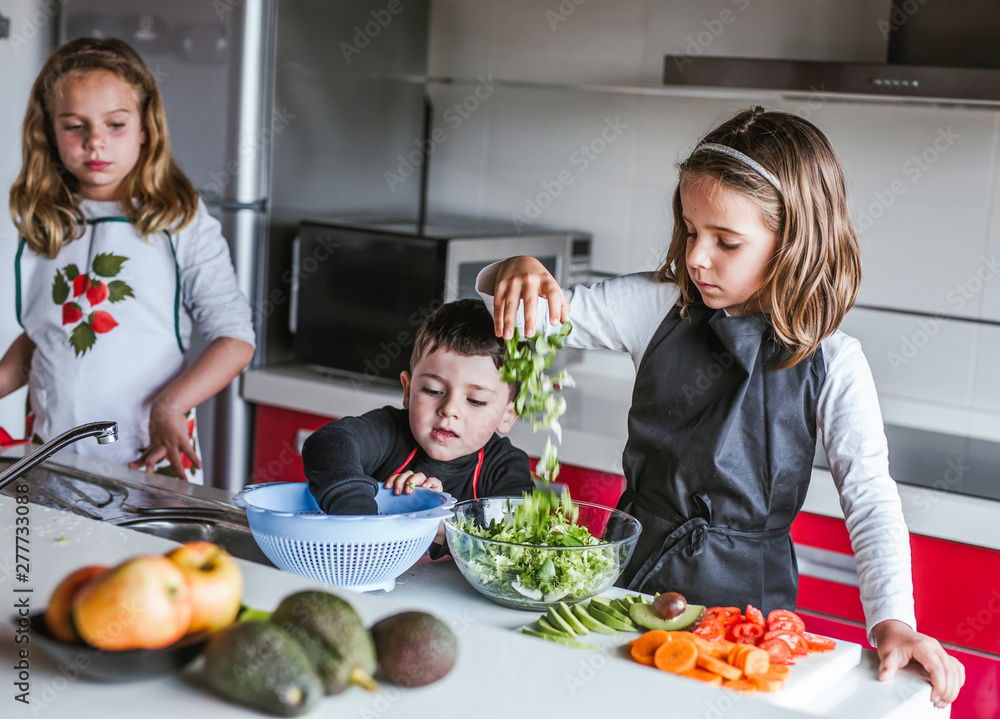 Little girls and boy Kids playing while while cooking healthy salad in ...