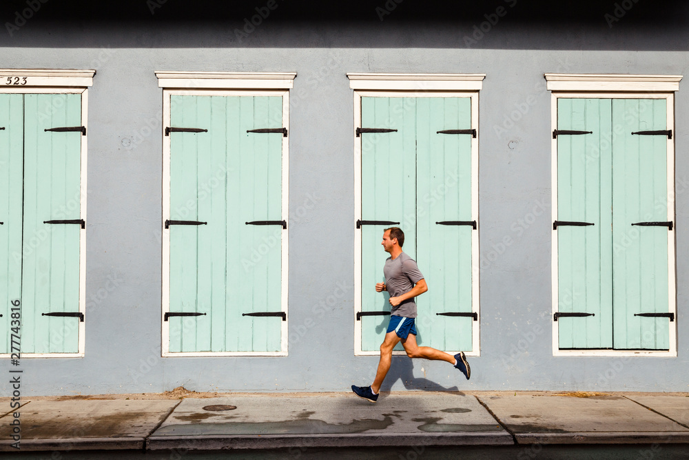 Side view of man running on pavement Stock Photo | Adobe Stock