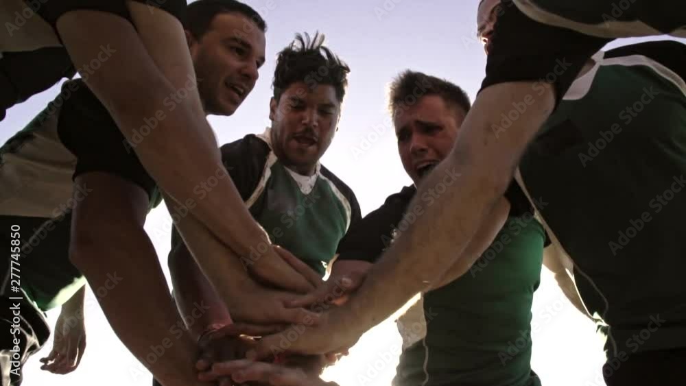 Rugby team putting their hands together before the match. Rugby players ...