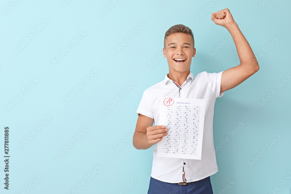 Happy boy with results of school test on color background Stock Photo ...