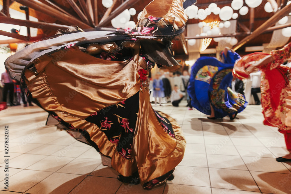 Beautiful gypsy girls dancing in traditional gold floral dress at ...