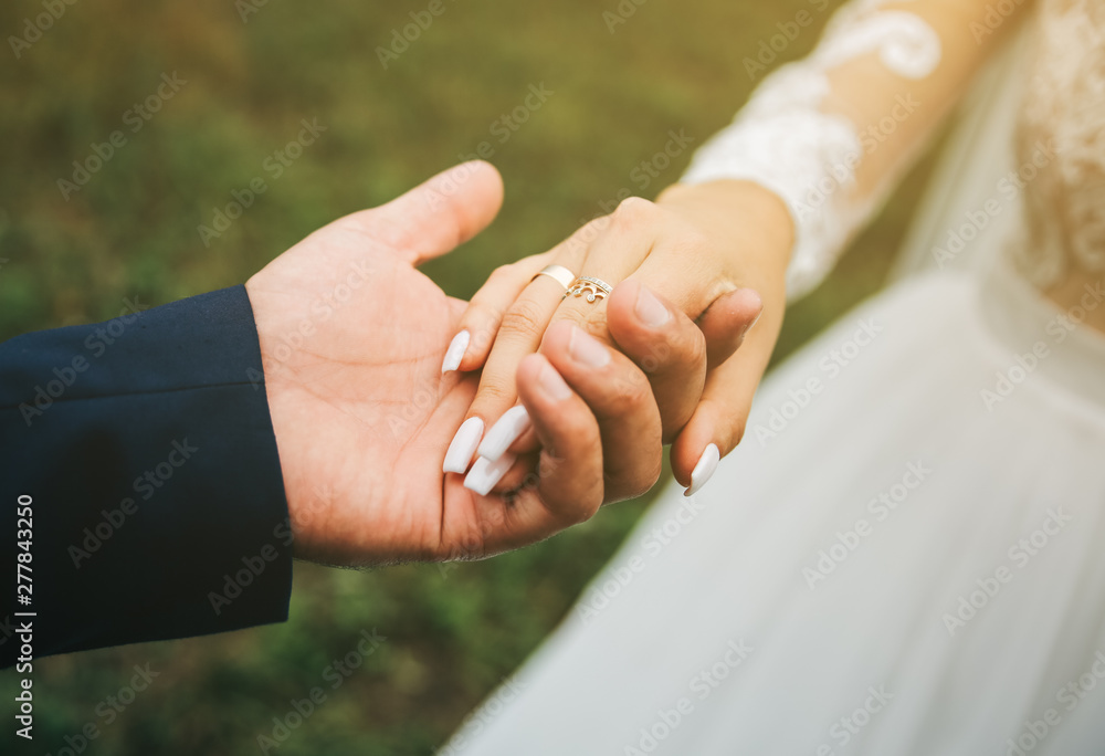 Groom and bride are holding hands. Happy wedding couple photo. Romantic ...