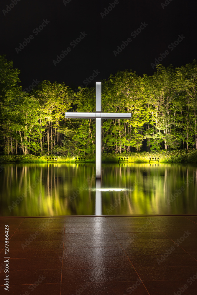 Cross on the water with an inverted reflection in a beautiful nature ...