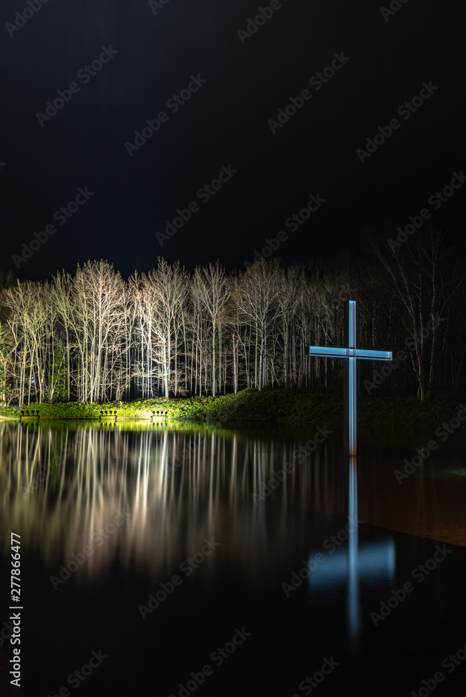 Cross on the water with an inverted reflection in a beautiful nature ...