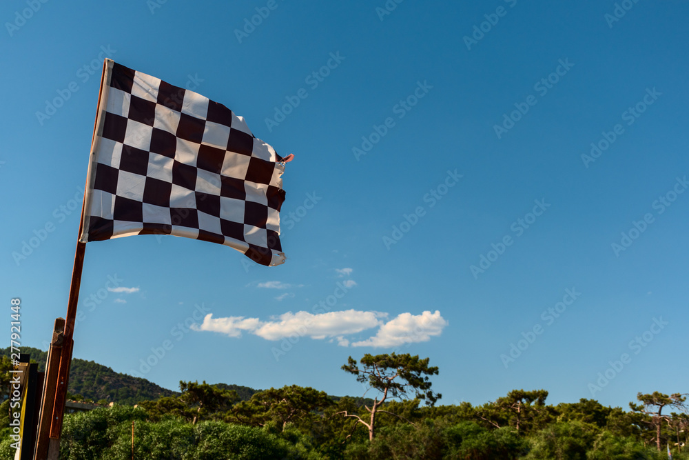 black white checkered wind flag on tropical beach Stock Photo | Adobe Stock