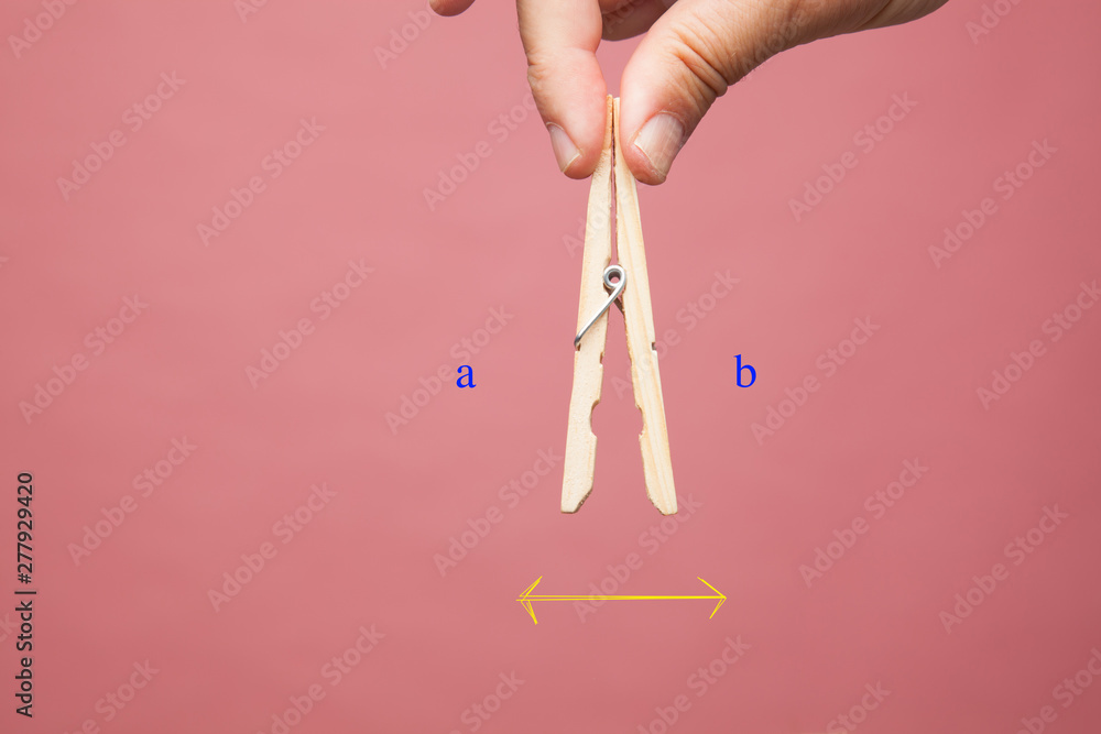 Mano que sujeta una pinza de extender la ropa, la pinza en formato ...