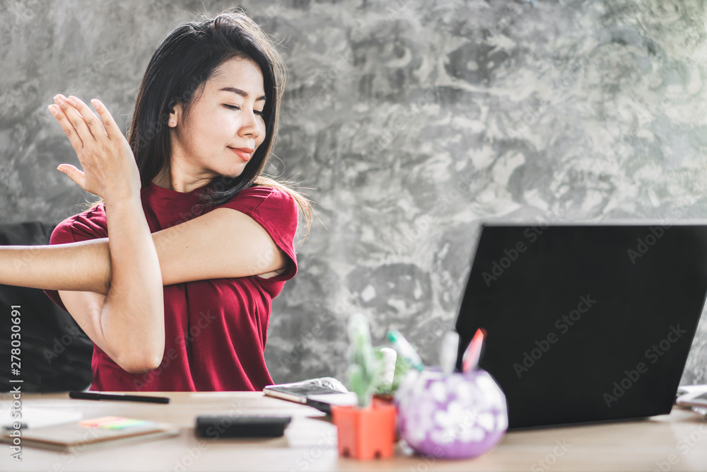 Asian female business woman stretching arm to relax muscle of shoulder ...