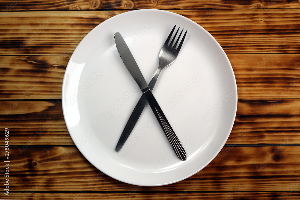 Fork And Knife Crossed On Plate
