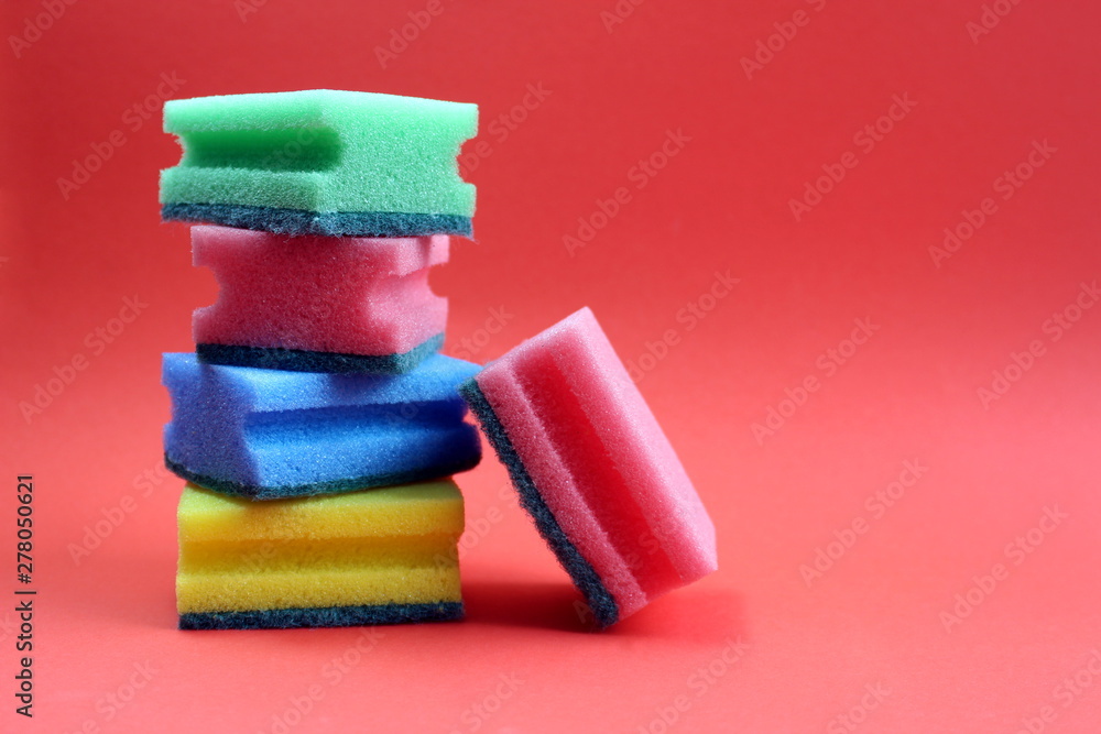 Folded scouring sponges in a single stack on a red background. Stock ...
