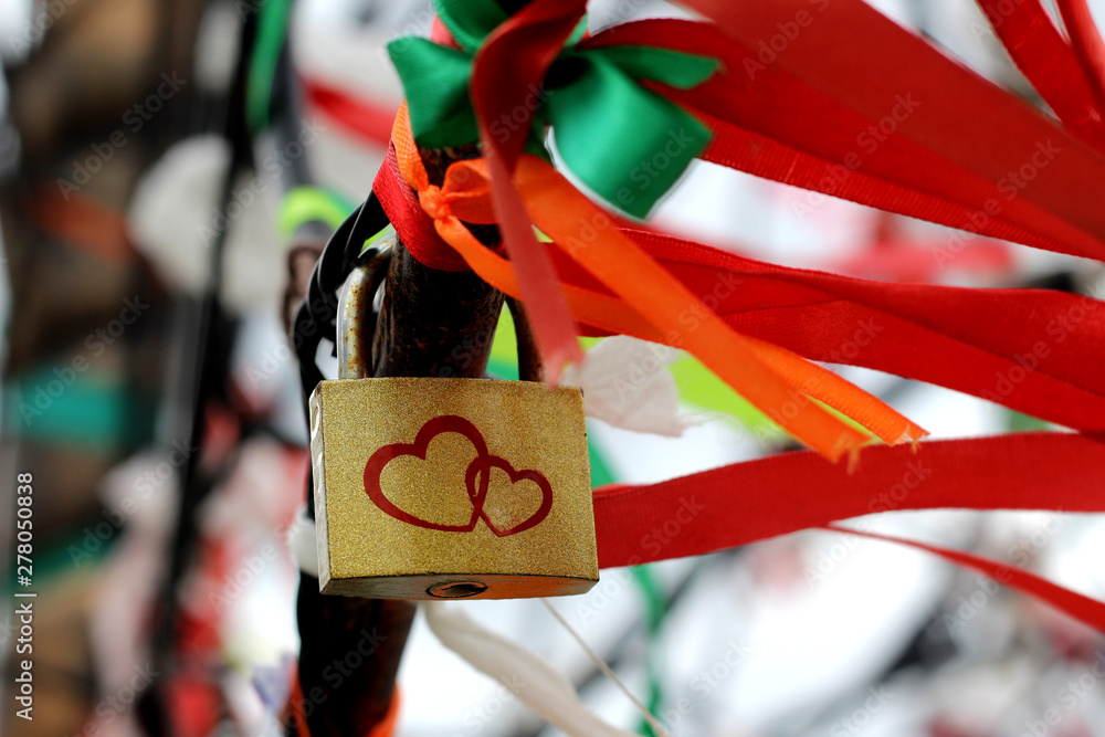 The lock, a symbol of love and loyalty, hangs on iron bars. A piece of ...